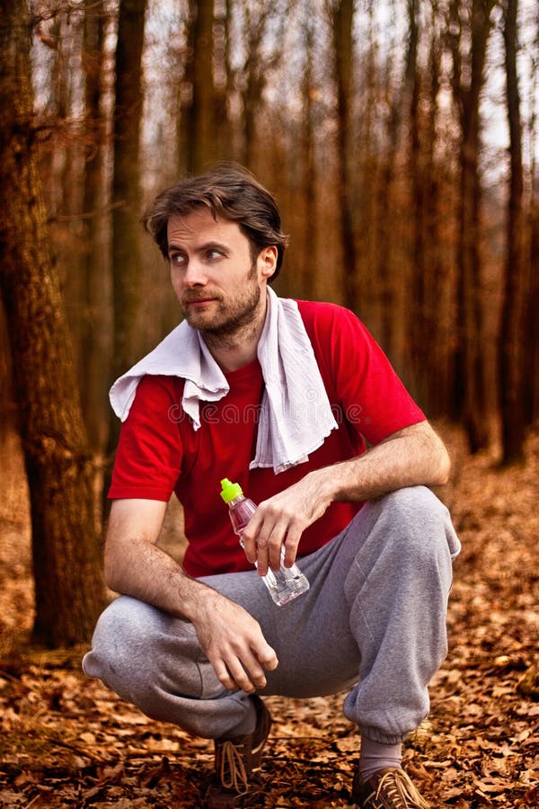 Runner Man Having a Rest after Jogging Workout in Forest Stock Image ...