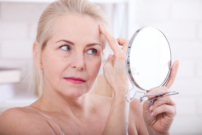 Forty Years Old Woman Looking At Wrinkles In Mirror Plastic Surgery