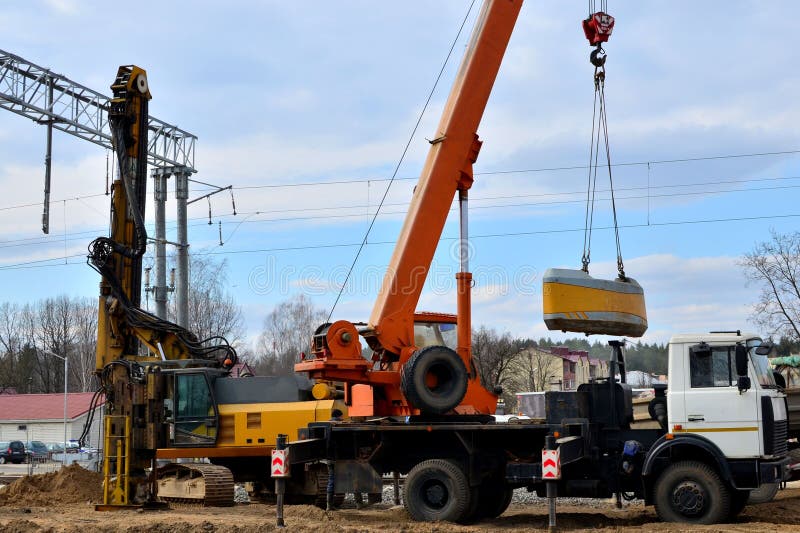 Foundation Piles Drilling Machine and Mobile Crane on the Construction ...