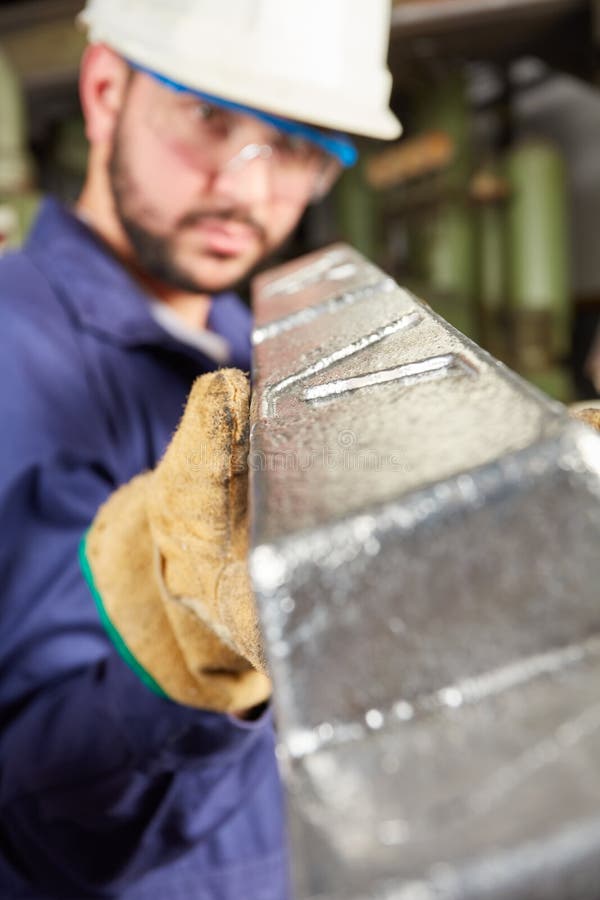 Foundry Worker in a Protective Mask Looks Inside the Vat in Which the ...