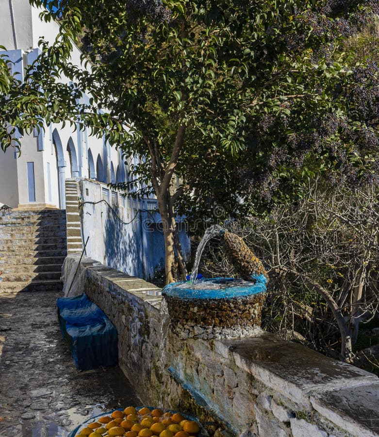 A Fountain in Along a River in a Historical Blue Town Stock Photo ...