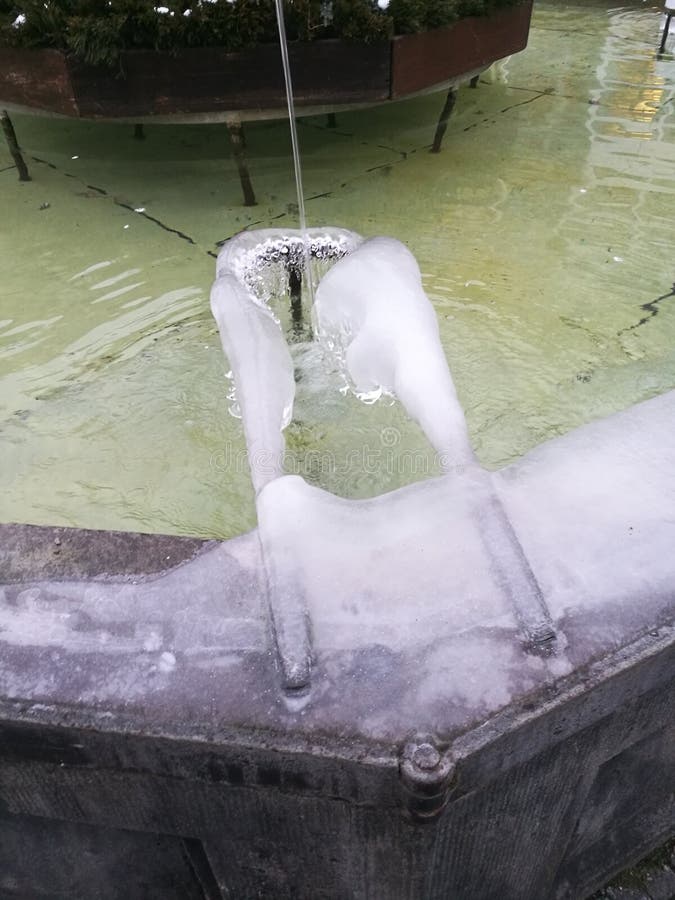 Fountain in a frozen pondv stock image. Image of pond - 84787929