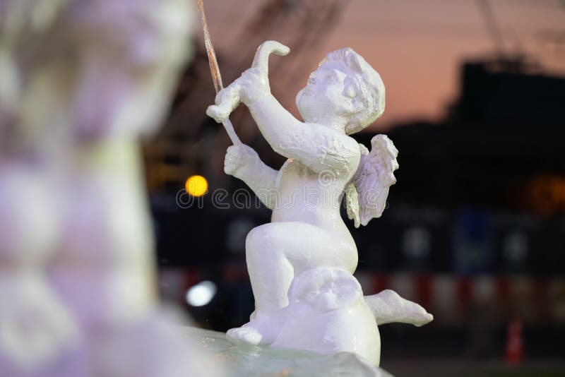 The Fountain Has a White Cupid Statue Holding a Bow and Arrow Panel ...