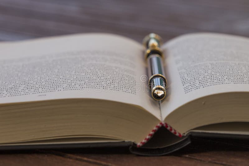 Fountain pen on book stock photo. Image of opened, novel - 58340230