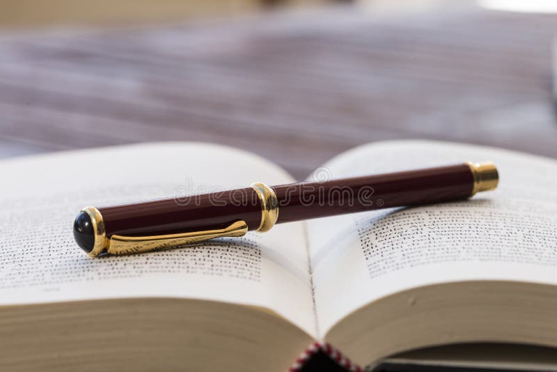 Fountain pen on a book stock image. Image of student - 58340595