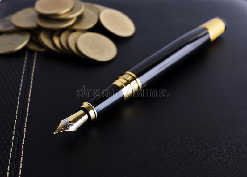 Fountain Pen and Coins Stack on Leather Book for Business Finance ...