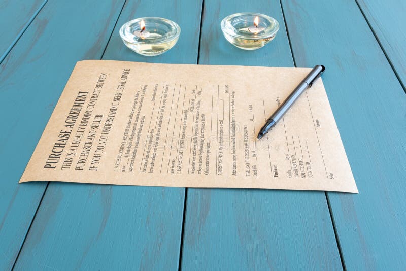 Fountain Pen Over a Contract on Brown Paper Surrounded by Lit Candles ...