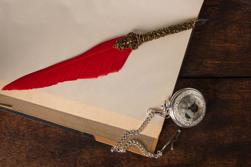 Fountain Pen with Red Feather on a Notebook and an Old Watch, Top View ...