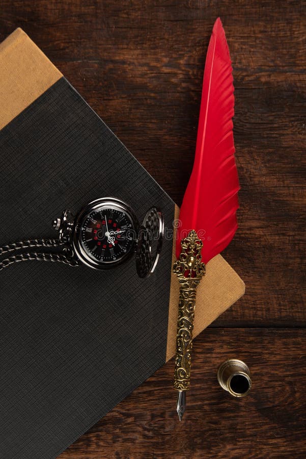 Fountain Pen with Red Feather on a Notebook and an Old Watch, Top View ...