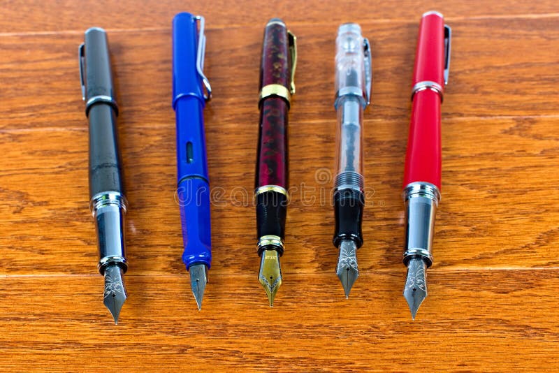 Fountain Pens on a Table stock image. Image of fountain - 398544881