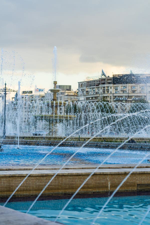 Fountain at Unirii Square in Downtown of Bucharest. Unirii Boulevard in ...