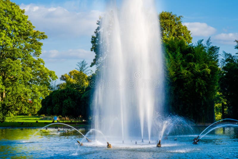 Fountain Water Jets and Splashes in Lake at Park Stock Photo - Image of ...