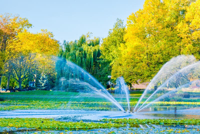 Fountain Water Jets and Splashes in Lake at Park Stock Image - Image of ...