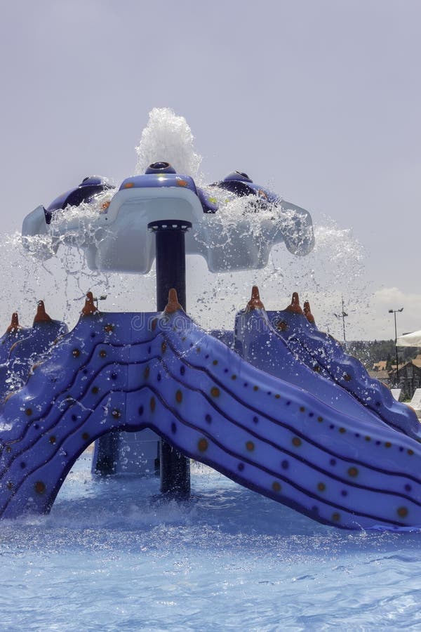 Fountain with water slide stock photo. Image of park - 57936402