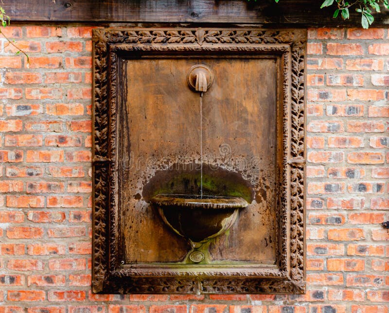 Fountain with Water Spout on Wall - Metal Frame with Fountain Against ...