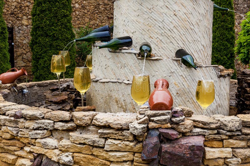 Fountain with White Wine Pouring from Bottles Stock Image - Image of ...