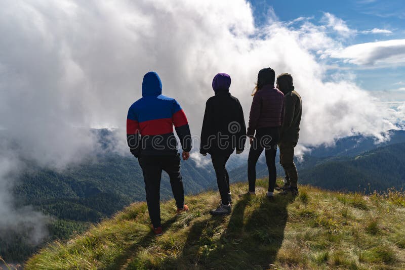 The Four Active People Standing on the Mountain with a Beautiful View ...