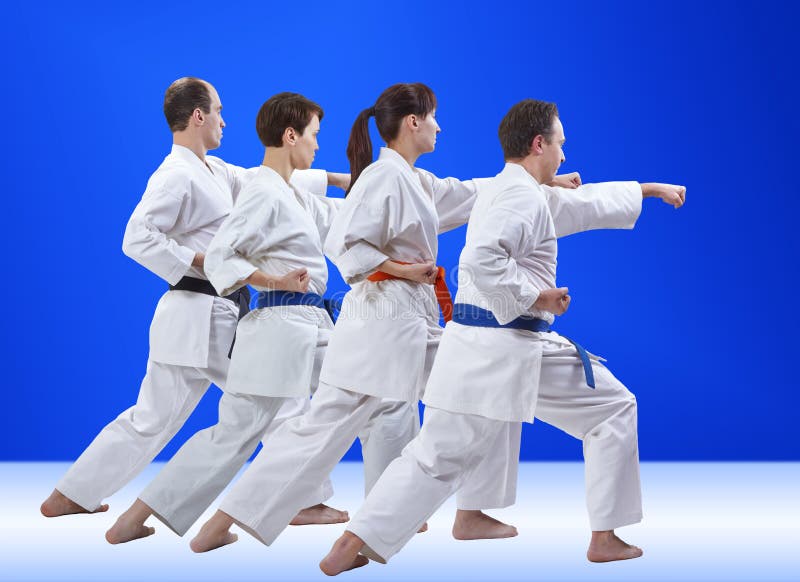 Four Adult Athletes are Training Punch on a Light Blue Background Stock ...