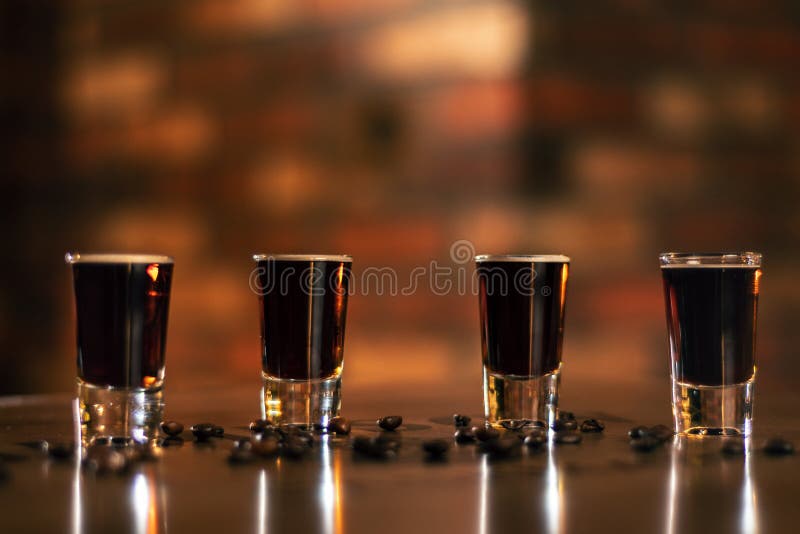 Four Alcohol Coffe Shot and Coffee Beans on the Wooden Table Stock ...