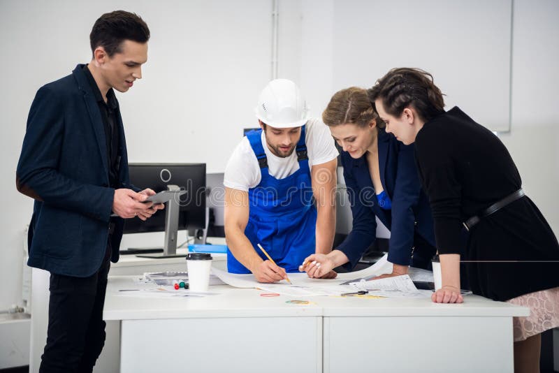 Four Architects Standing Around Table Having Meeting Stock Photo ...