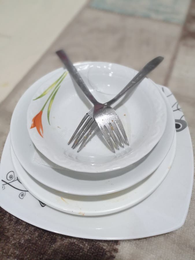 Four Arranged Plates Along with Two Forks Stock Photo - Image of four ...