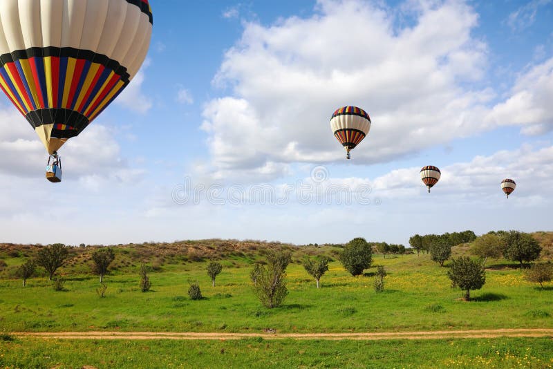 Four Balloons with a Passenger Basket Stock Photo - Image of blue, trip ...