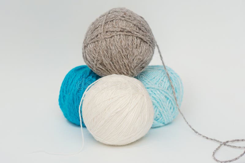 Four Balls of Yarn for Knitting Lie in the Form of a Pyramid on a White ...