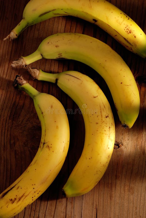 Four bananas on the table stock image. Image of banana - 35818935