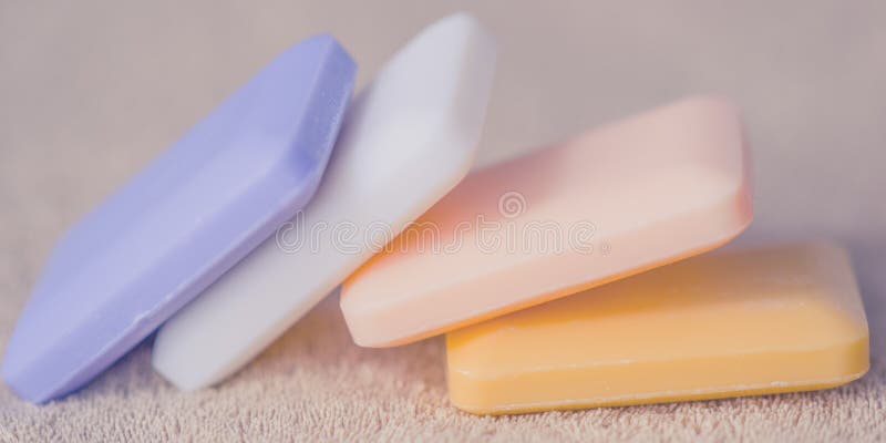 Four Bars of Soap of Different Colors on a Brown Towel. Stock Image ...