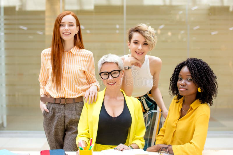 Four Beautiful Models in in Trendy Clothes Looking at the Camera Stock ...