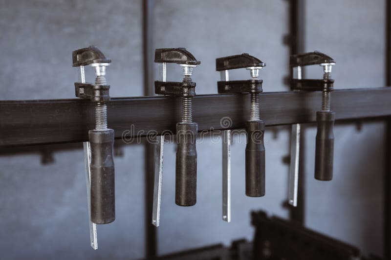 Four Black Clamps Mounted on Metal Rack on the Construction Site. the ...