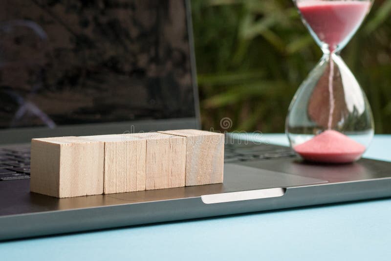 Four Blank Wood Toy Blocks in a Row Next To Sand Timer Stock Photo ...