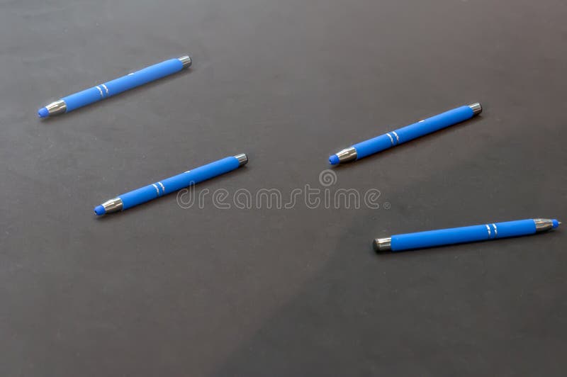 Four Blue Pens Lying on a Table Stock Photo - Image of button, metallic ...
