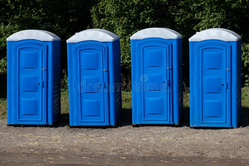Four Blue Plastic Portable Toilet Stalls in the Park Stock Image ...