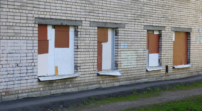 Four Boarded-up Windows in a White Brick Wall Stock Photo - Image of ...