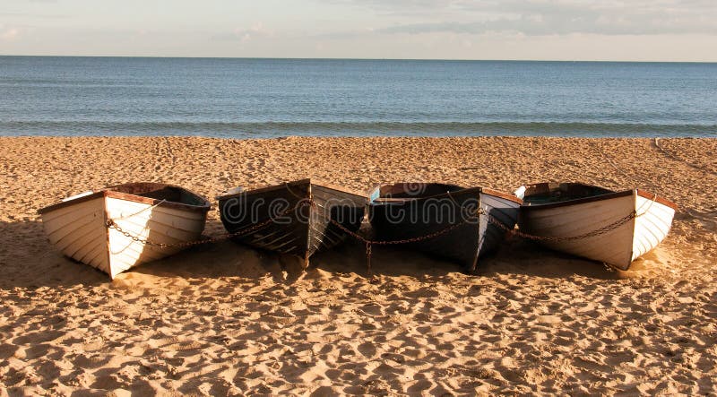 Four boats on the beach. stock photo. Image of ocean - 70411482