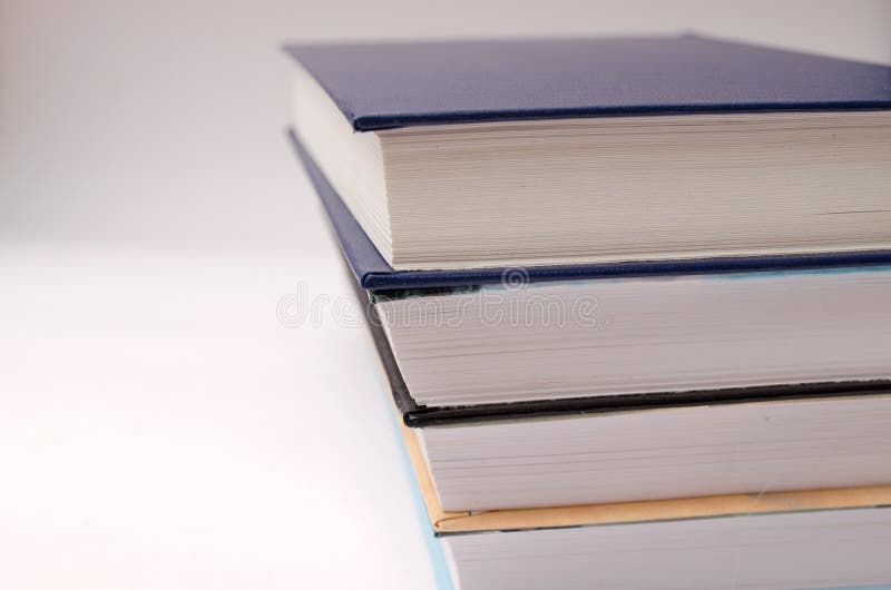 Four books stacked on desk stock photo. Image of bookcase - 284877872