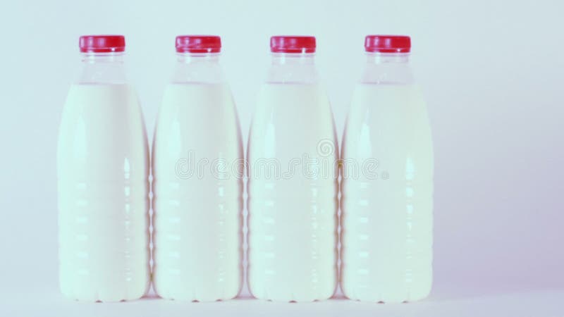 Four Bottles of Milk with Red Cap Isolated on Stock Video - Video of ...