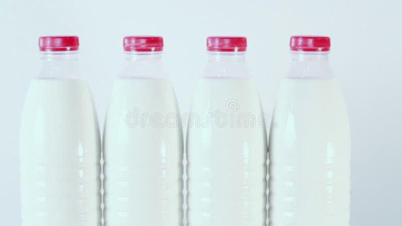 Four Bottles of Milk with Red Cap Moves Isolated Stock Footage - Video ...
