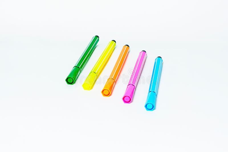 Four Bright Colored Pens Lined Up in a Row on Top of a Table Stock ...