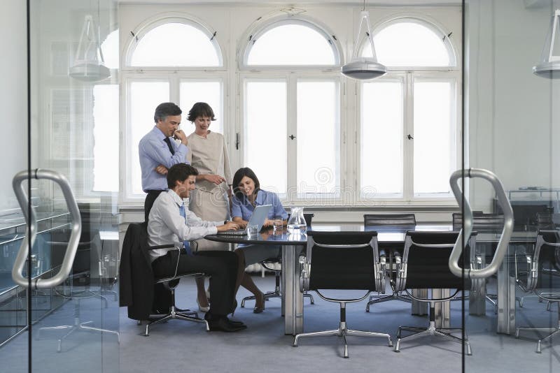 Four Business People Using Laptop in Office Stock Image - Image of ...