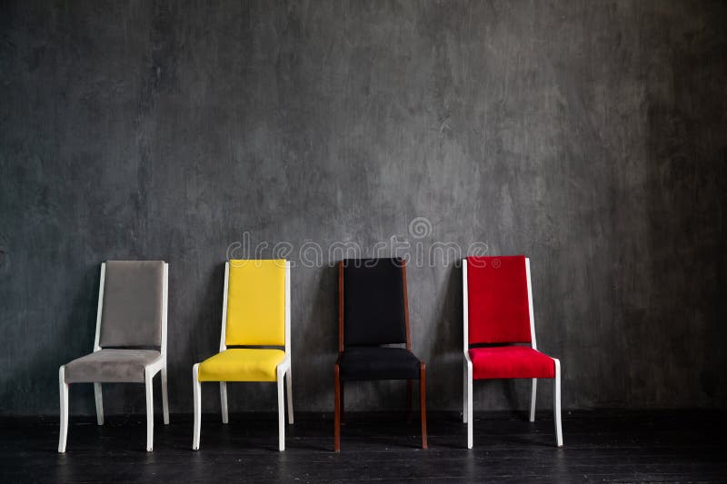 Four Chairs of Different Colors in the Interior of a Gray Room Stock ...