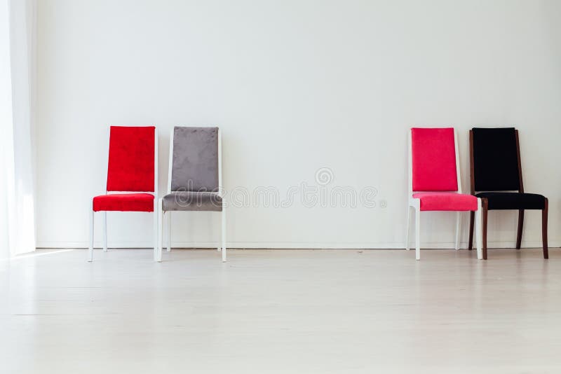 Four Chairs are Arranged in a Row Against a White Wall for Interior ...