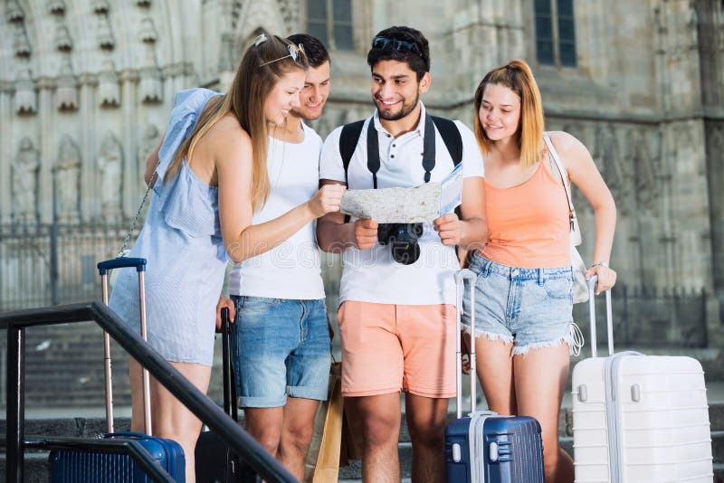 Four Cheerful Traveling Young People with Map Stock Photo - Image of ...