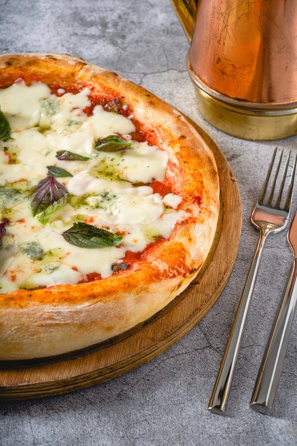 Four Cheese Neapolitan Pizza on Wooden Cutting Board on Stone Table ...