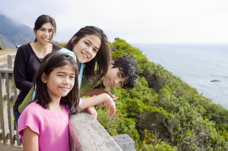 Four Children Along the Ocean Shore Stock Photo - Image of family ...