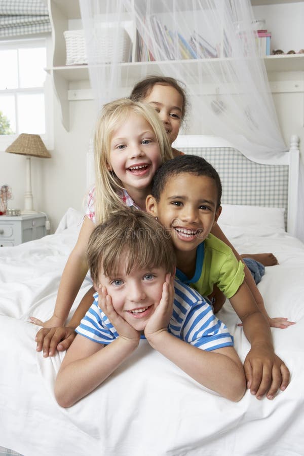 Four Children Playing on Bed Together Stock Image - Image of friendship ...