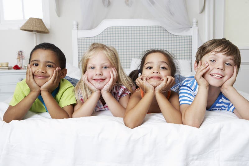 Four Children Playing on Bed Together Stock Photo - Image of female ...