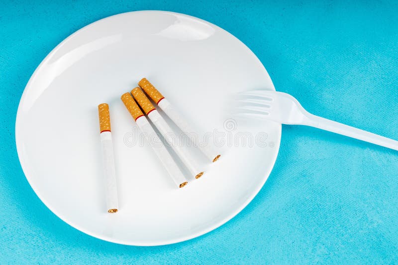 Four Cigarettes on a Plate and a Disposable Plastic Fork Stock Image ...