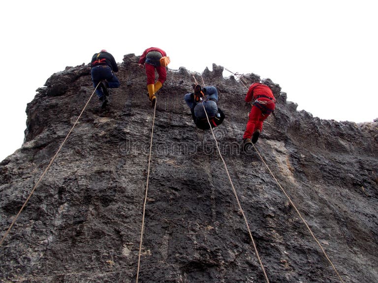 Four Climbers Rappelling Using the Single Rope Technique Editorial ...